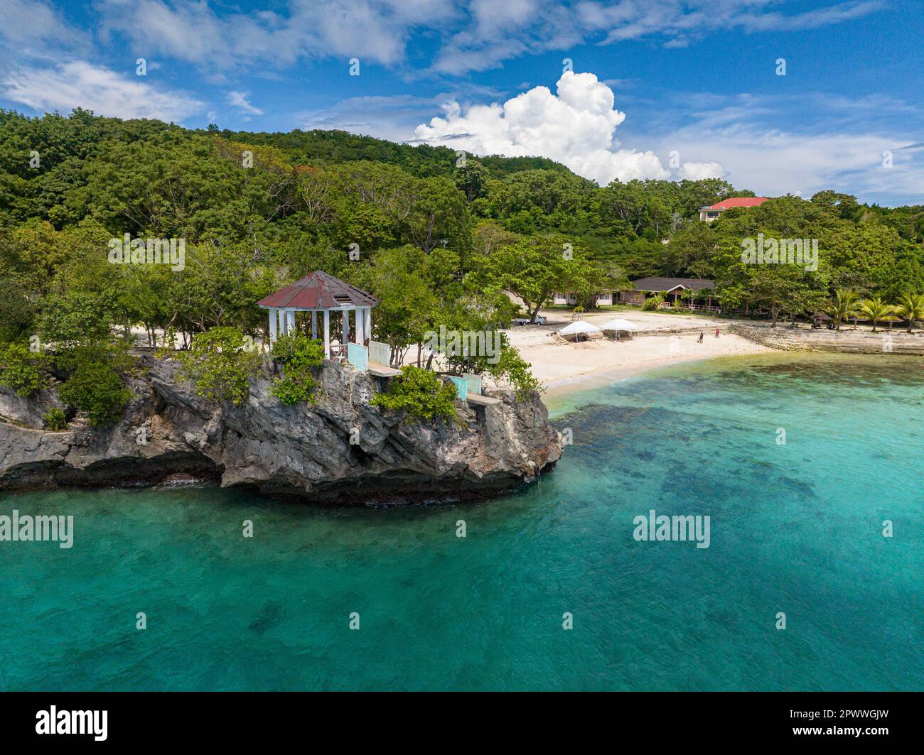 Aerial drone shot of glamorous Salagdoong Beach Resort with a overlooking sea view of tiny ...