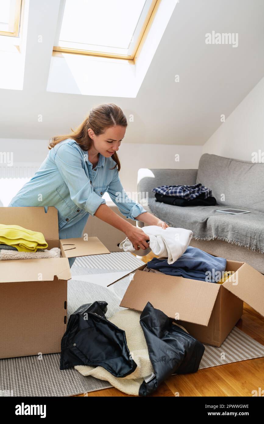 Woman packing clothes hi-res stock photography and images - Alamy