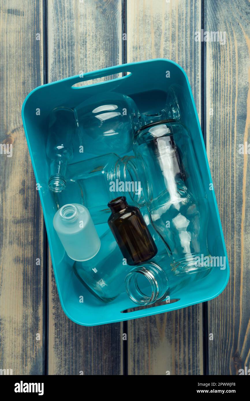 Vertical blue plastic container box full of transparent plastic and ...