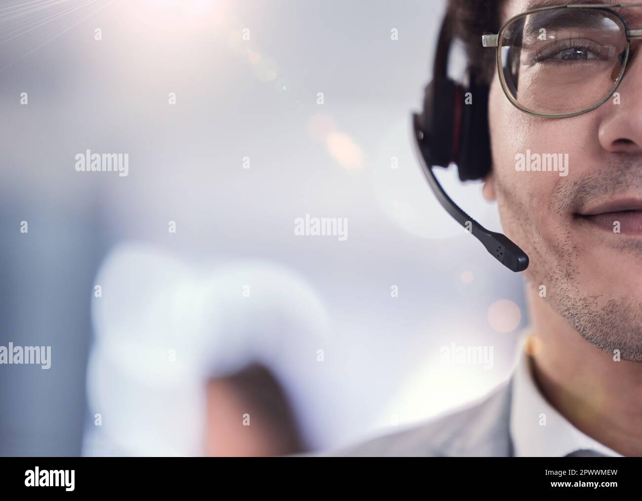 Hes fully dedicated to his job. a young male call center agent at work ...