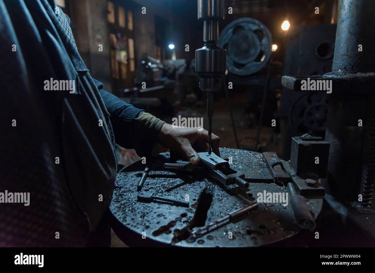 Srinagar, India. 01st May, 2023. A Labourer operates a machine inside a ...