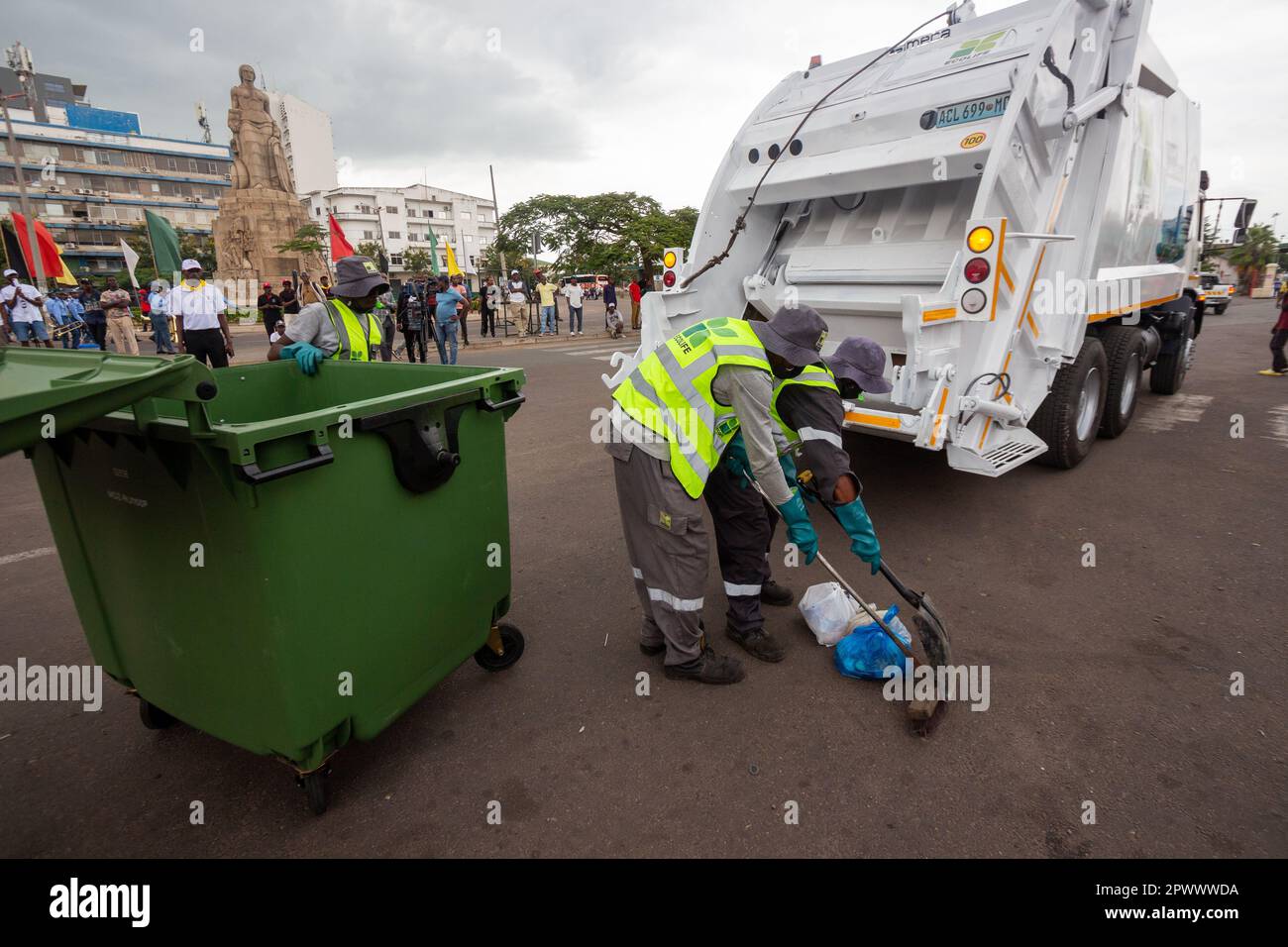 African Waste Collectors Preparing to Load Green Container onto Garbage ...