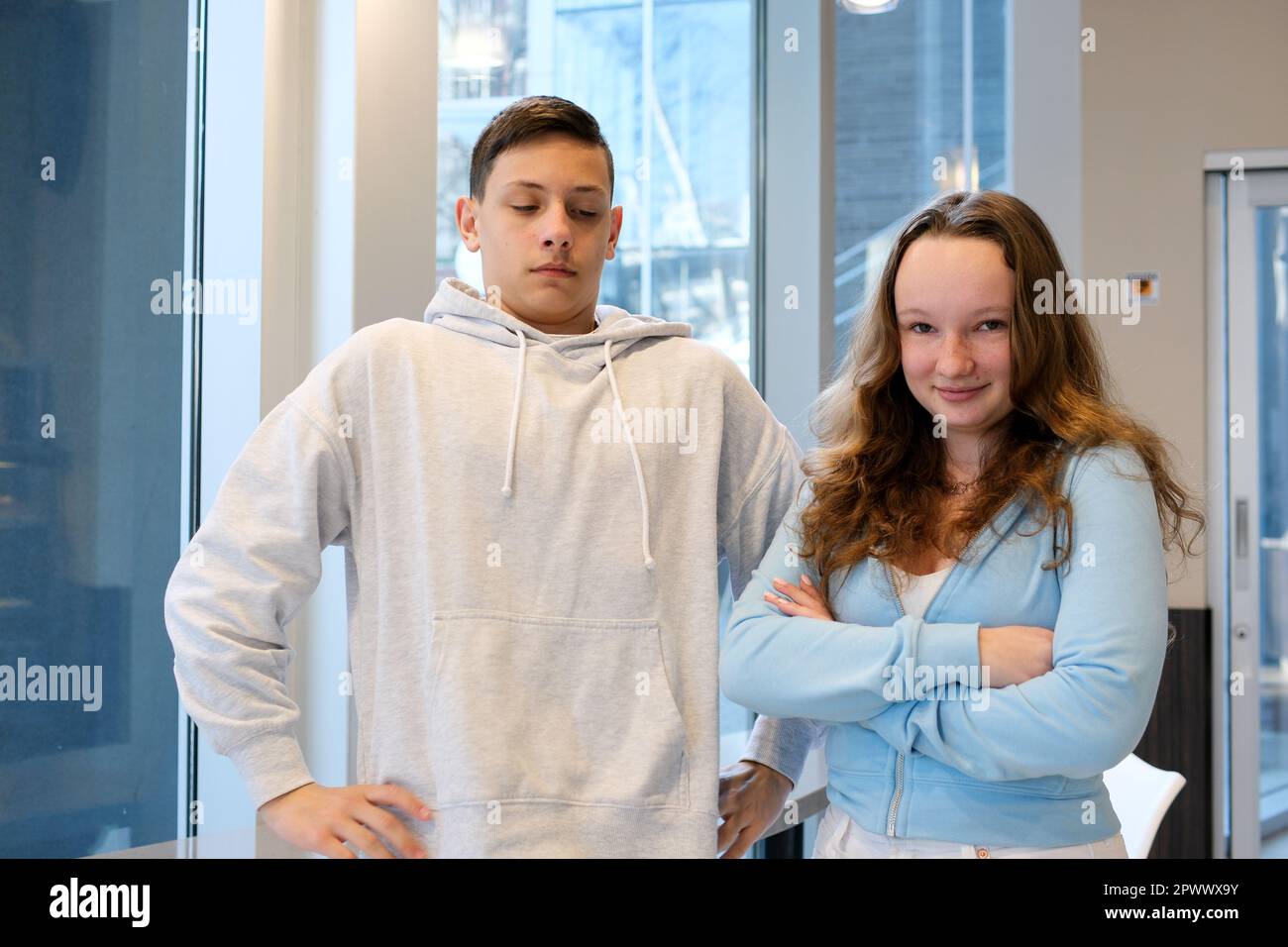 boy girl fooling around put hands on chest raise chest pout laugh make ...