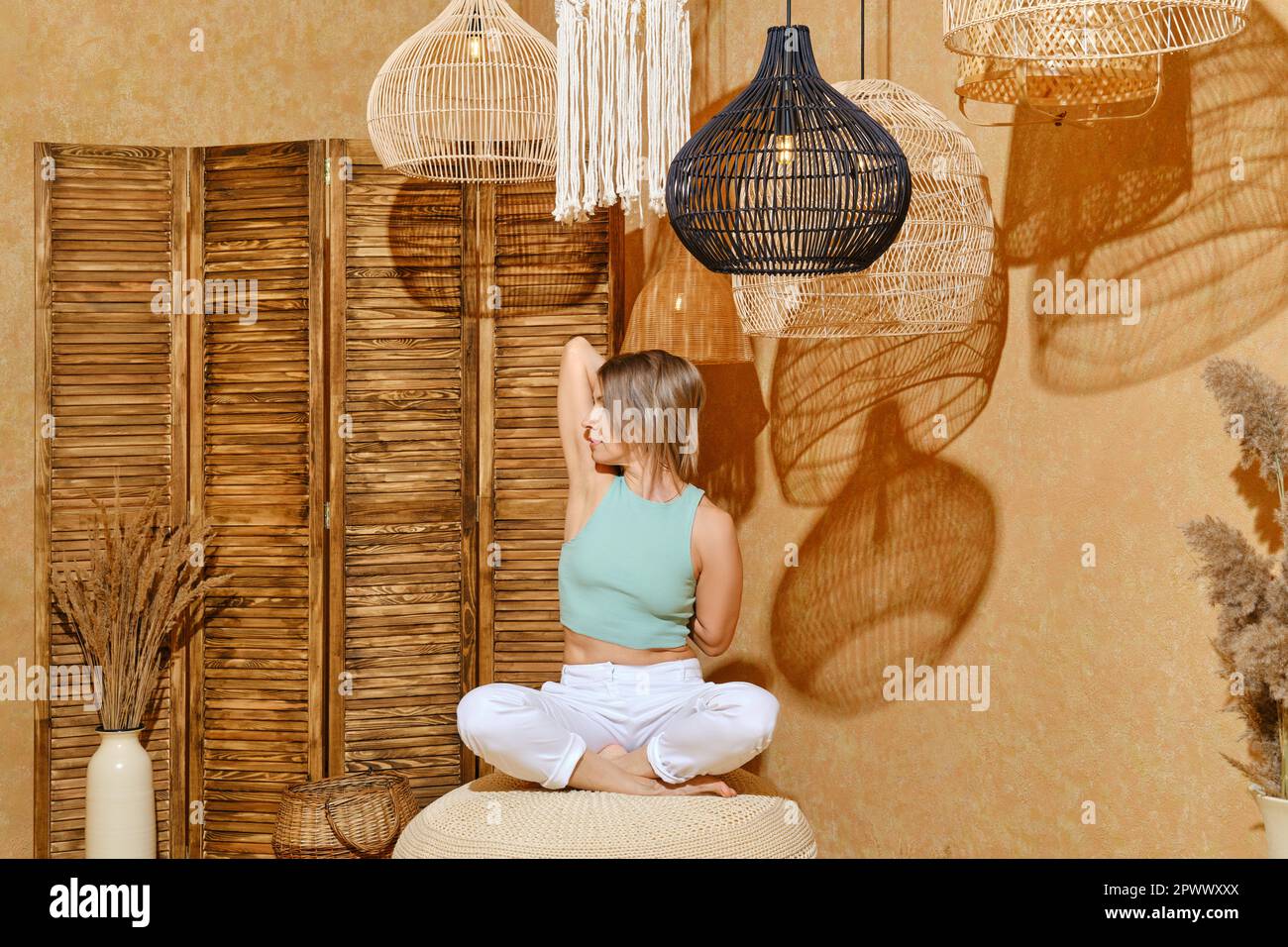 Yoga for senior people. Woman balancing on ottoman, stretching hands ...