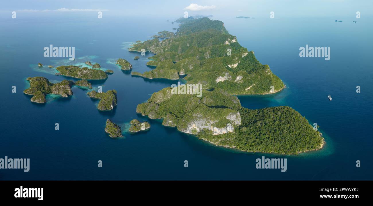 Biodiverse coral reefs surround the dramatic limestone islands that ...