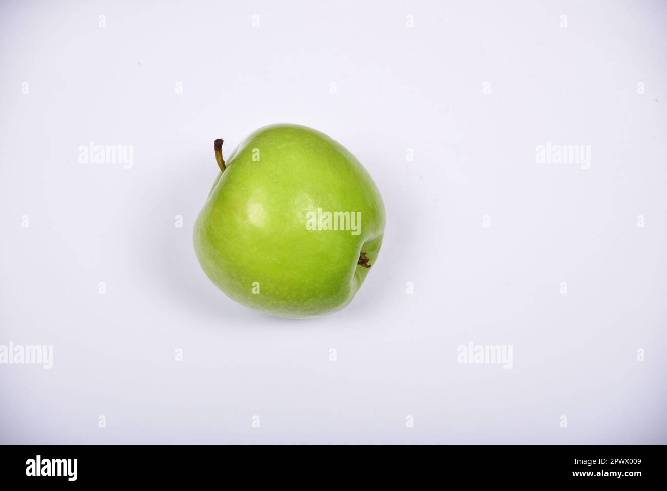 Green apple side view on an isolated background Stock Photo - Alamy