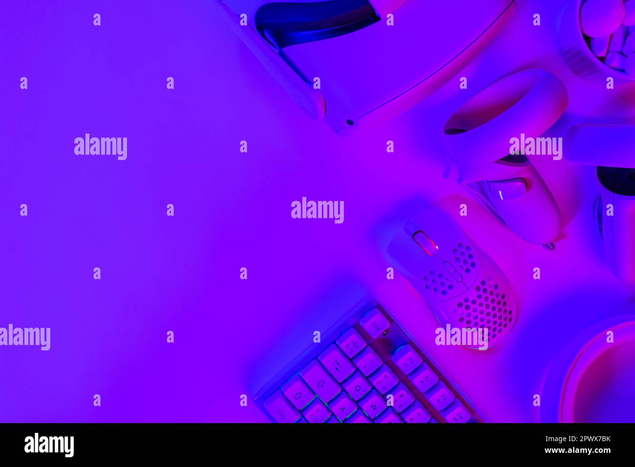 Modern gaming accessories on purple desk Stock Photo - Alamy