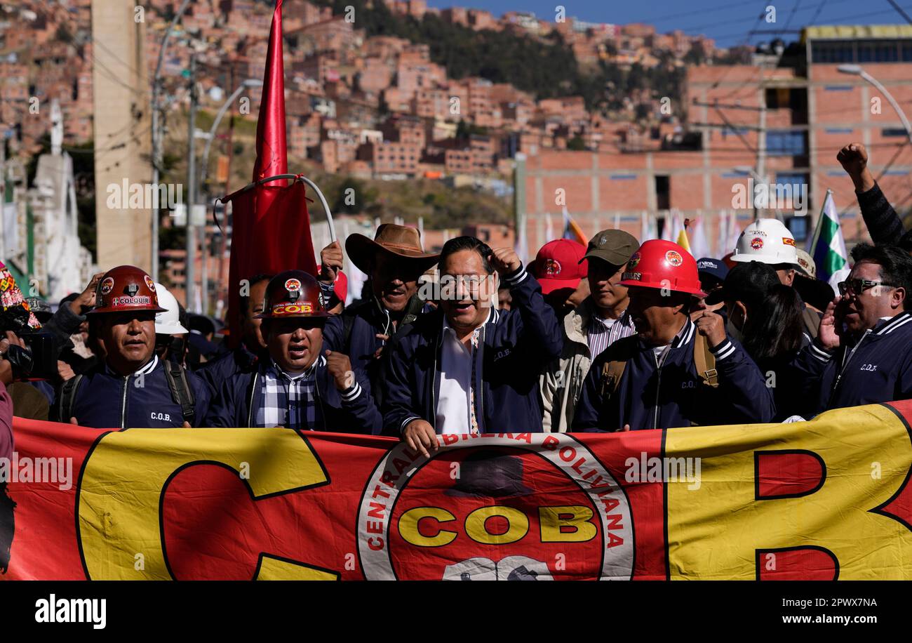 Bolivian President Luis Arce, center, shouts slogans during the May Day ...