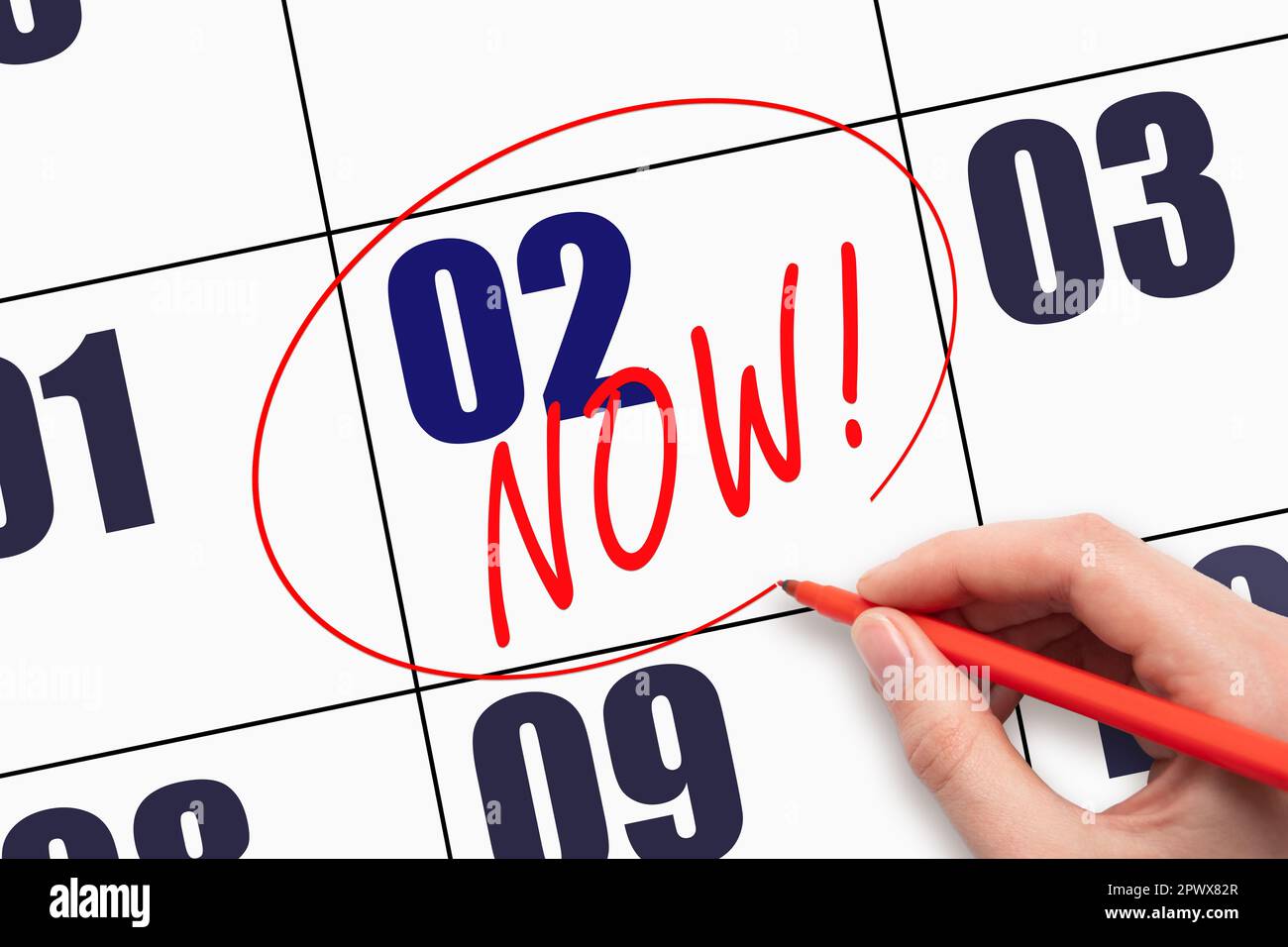 2nd day of the month. Hand writing text NOW and circling the calendar ...