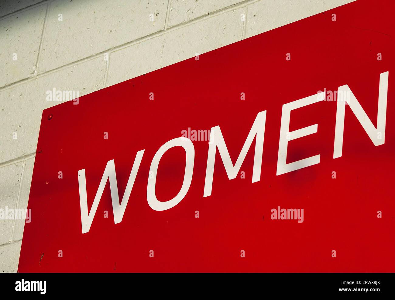 A bright red Woman sign on the wall Stock Photo - Alamy