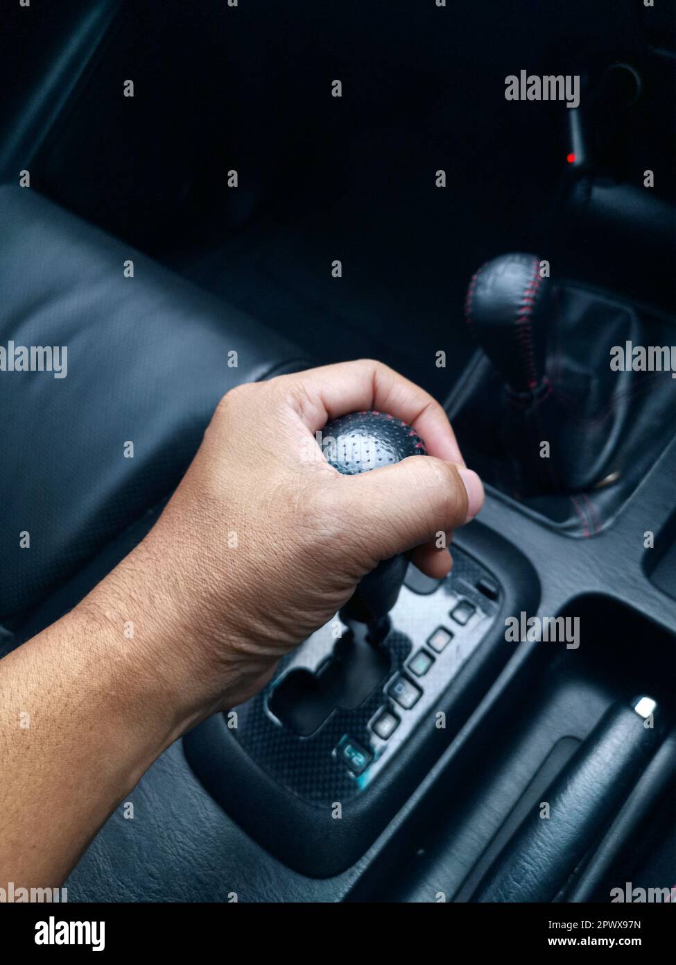 Detail of Hand in gear shift Stock Photo - Alamy