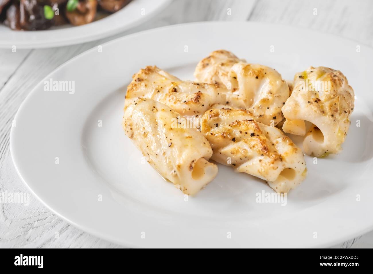 Portion of fried asian style calamari on the plate Stock Photo - Alamy