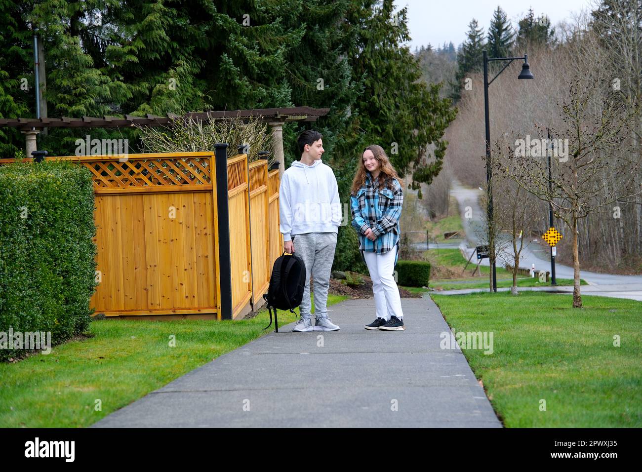teenage boy and girl spend home walking girl from school home together ...