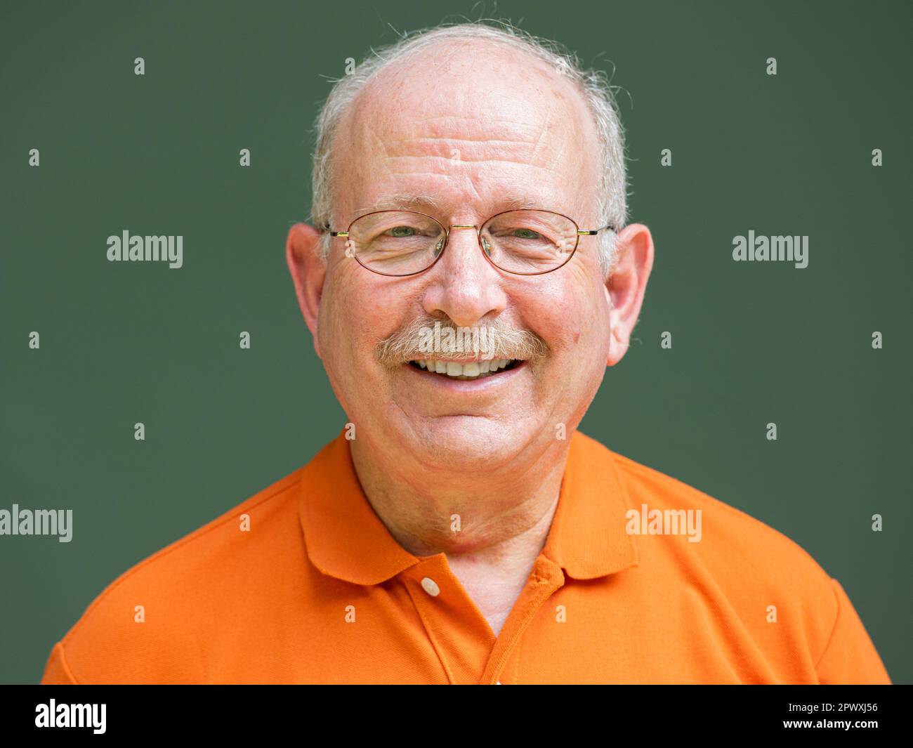 Portrait Of Grey Haired Senior Man With Mustache Wearing Eyeglasses And