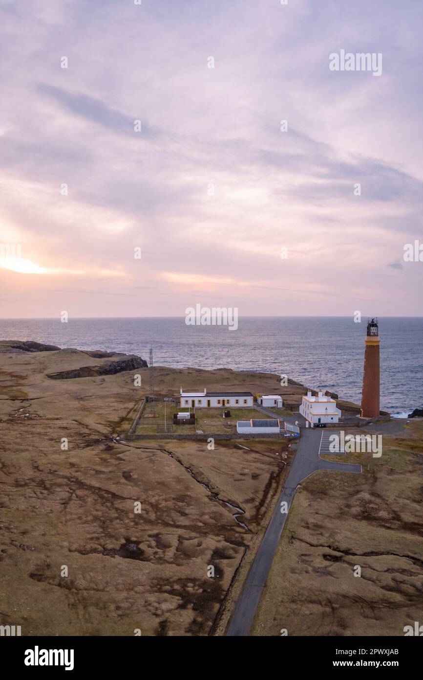 Aerial view of sunset and lilac sky over Butt of Lewis Lighthouse in ...