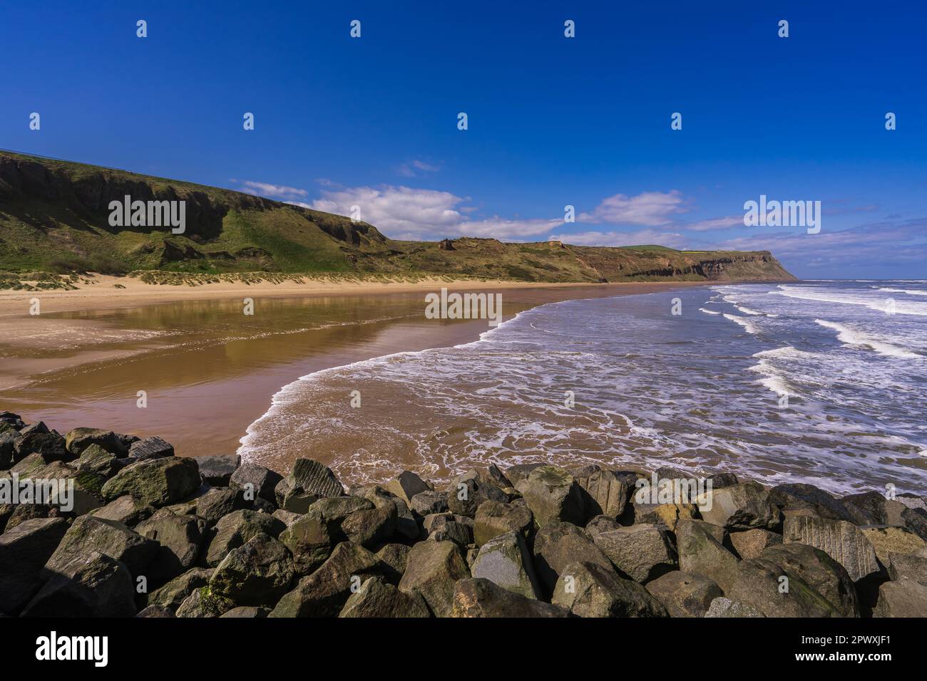 The beautiful pristine Cattersty Beach seen from the pier in ...