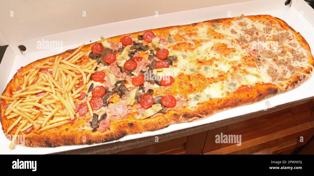 huge long pizza with tomato cheese mozzarella spicy salami mushrooms in ...
