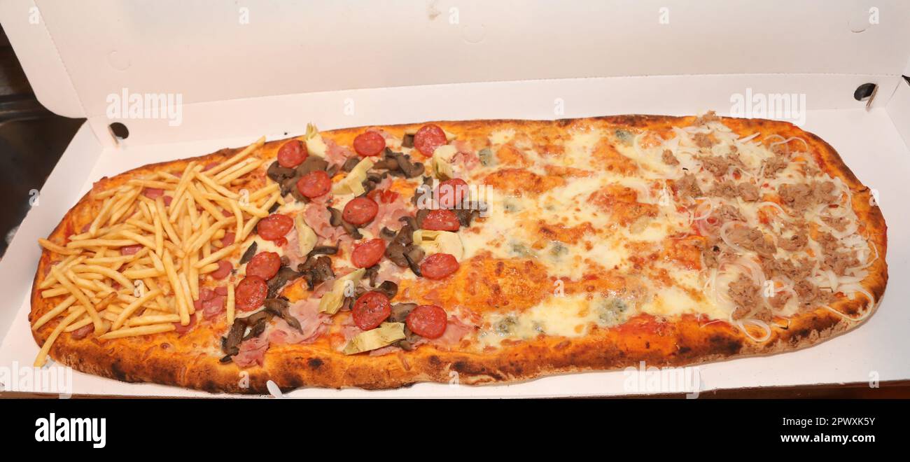 huge long pizza with tomato cheese mozzarella spicy salami mushrooms in ...