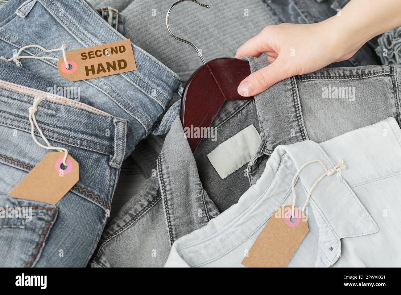 Clothes from females wardrobe on shelf of second hand store Stock Photo ...