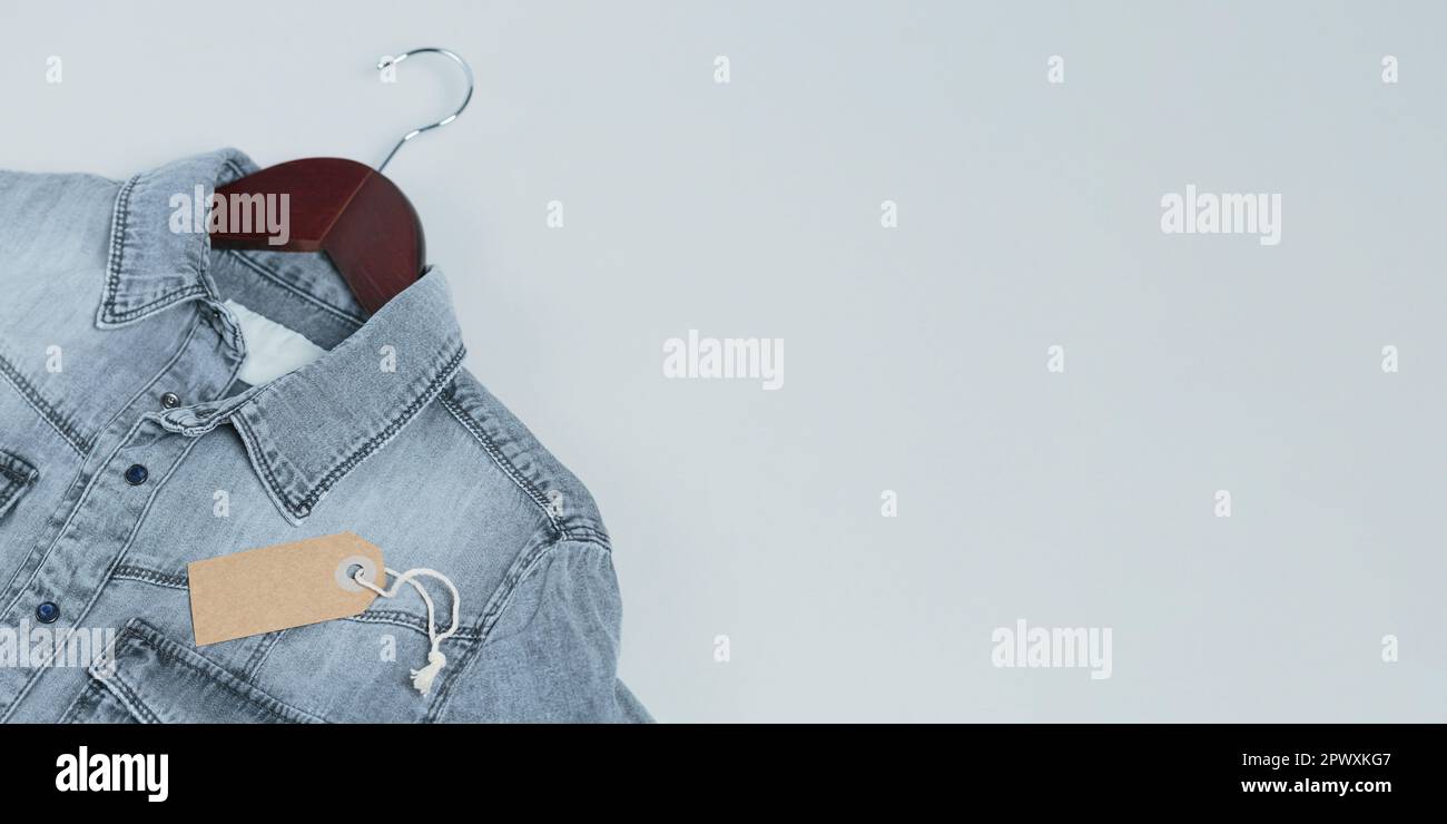 Gray denim shirt with empty tags on hanger on white background Stock ...