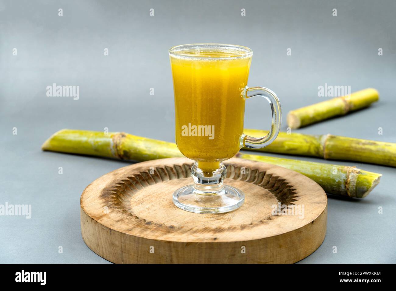 Fresh squeezed sugar cane juice with fresh cane sliced isolated on ...