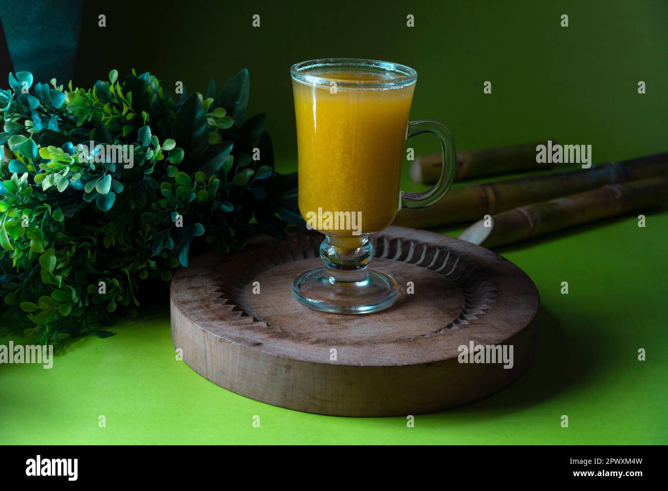 Fresh squeezed sugar cane juice with fresh cane sliced isolated on ...