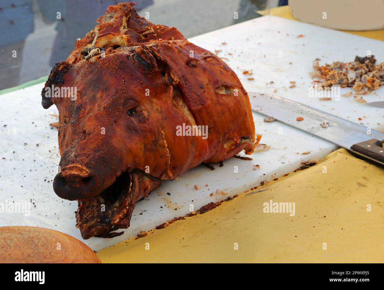 head of a roasted pork called PORCHETTA in the italian stand and big ...