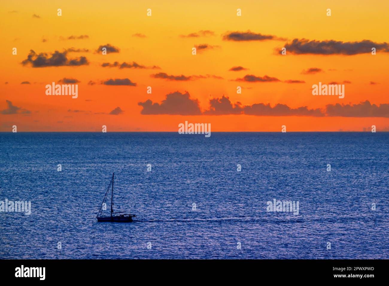 sunset with a view of the sea off Grenada in the Caribbean with a ...