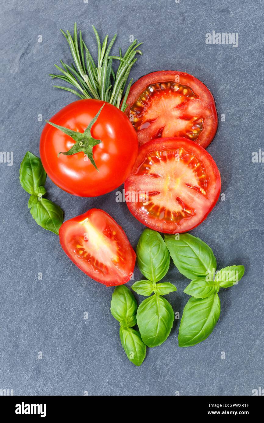 Tomatoes tomatos vegetables with basil portrait format from above on a ...