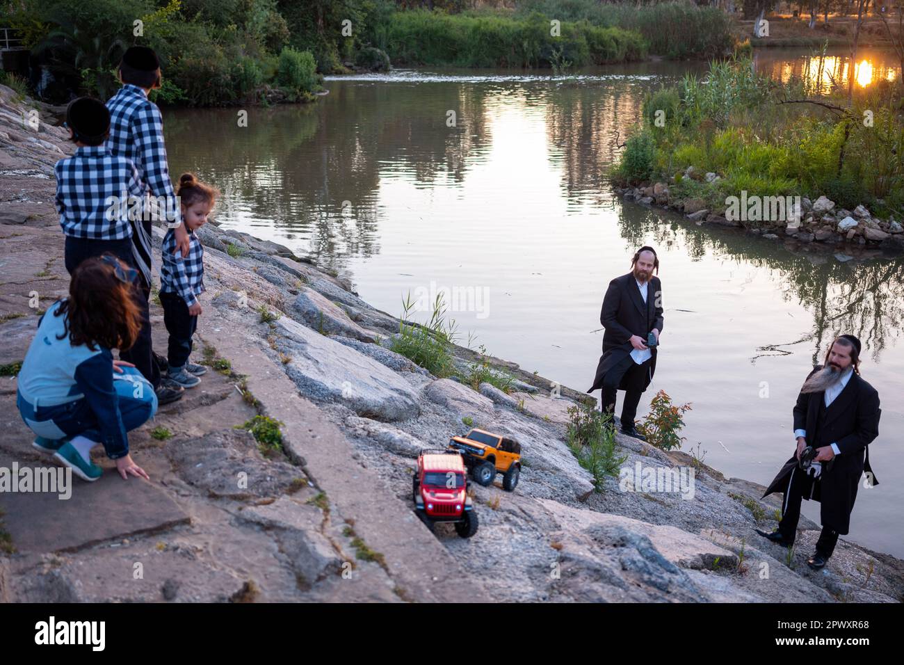 Ultra-Orthodox Jewish men play with remote control cars at a park in ...
