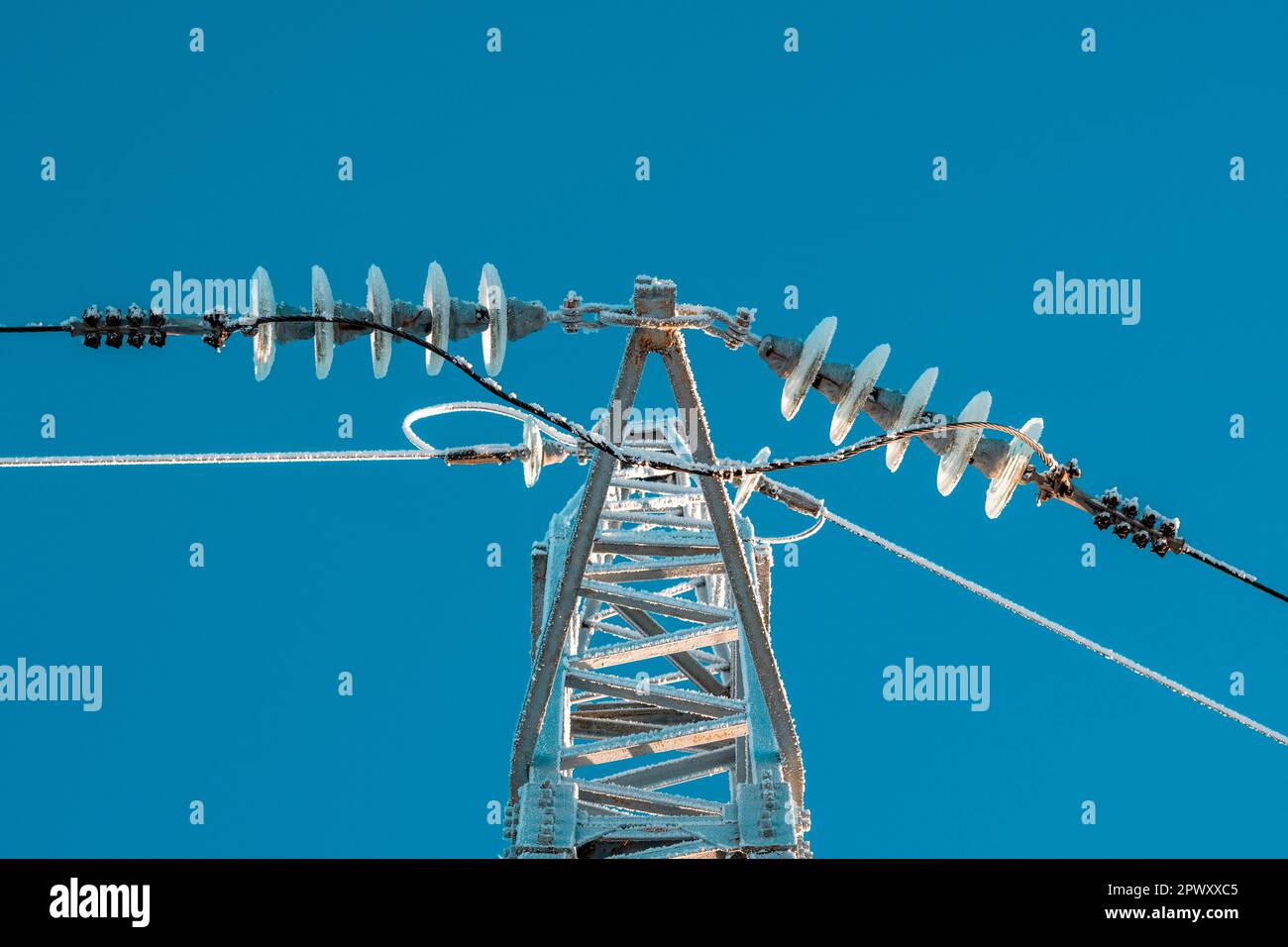 Frozen power line pylons. Hoarfrost on high voltage cables and ...
