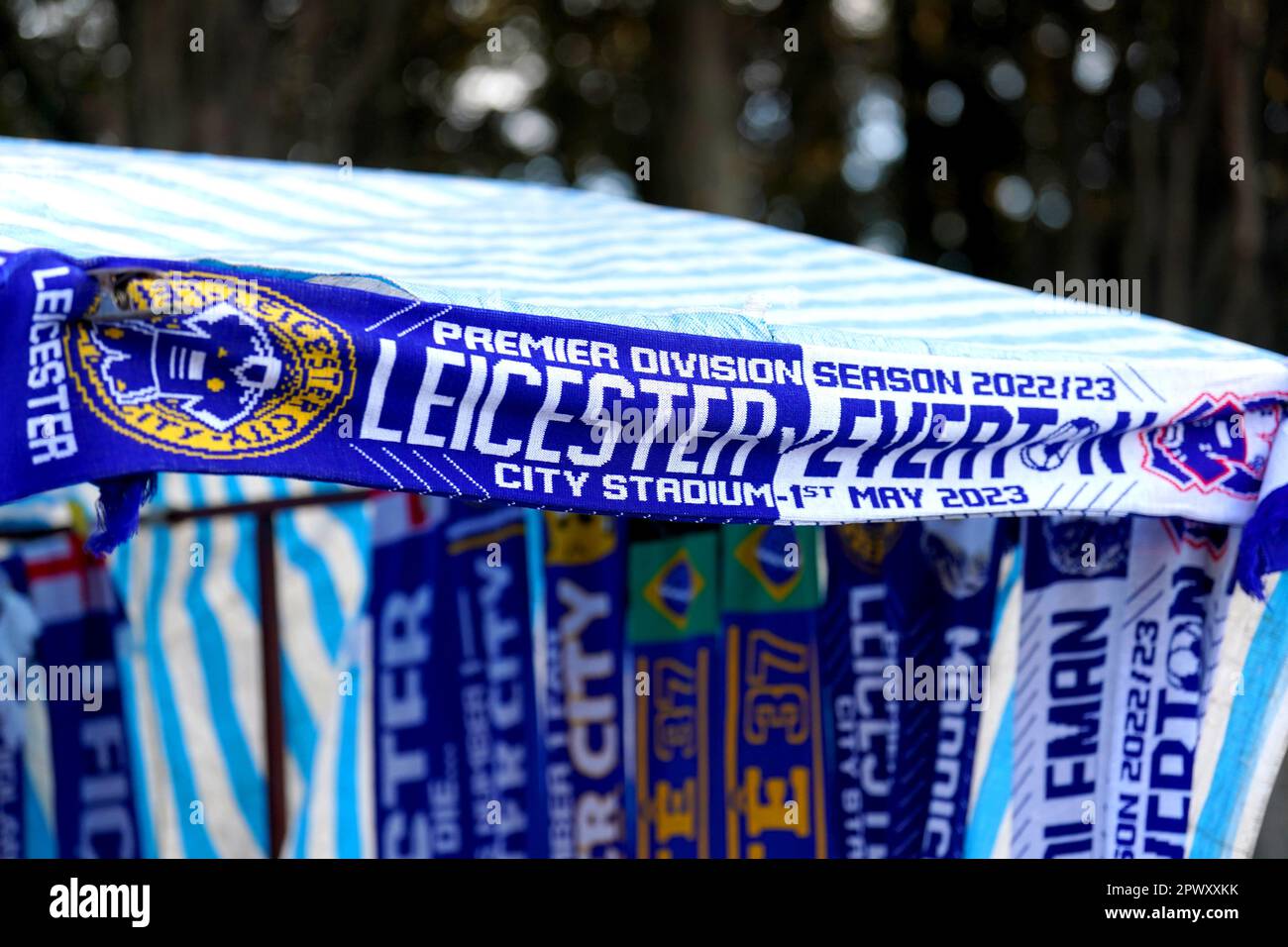 A commemorative match scarf is displayed at a street vendor stall ahead ...