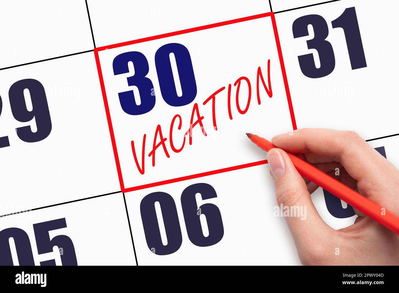 30th day of the month. Hand writing text VACATION on calendar date ...