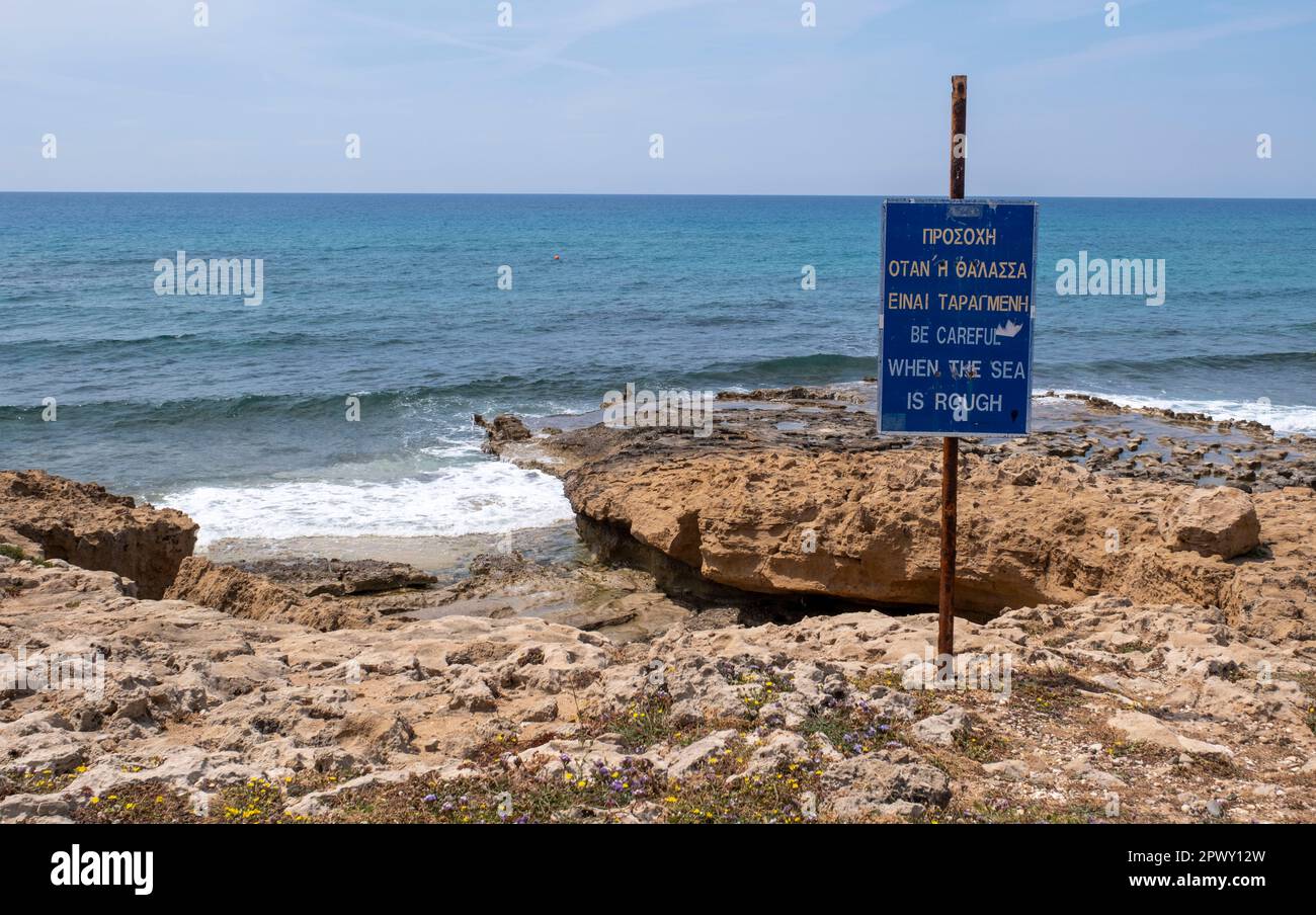 Warning sign for swimmers on the coastline at Chloraka, Paphos, Cyprus ...