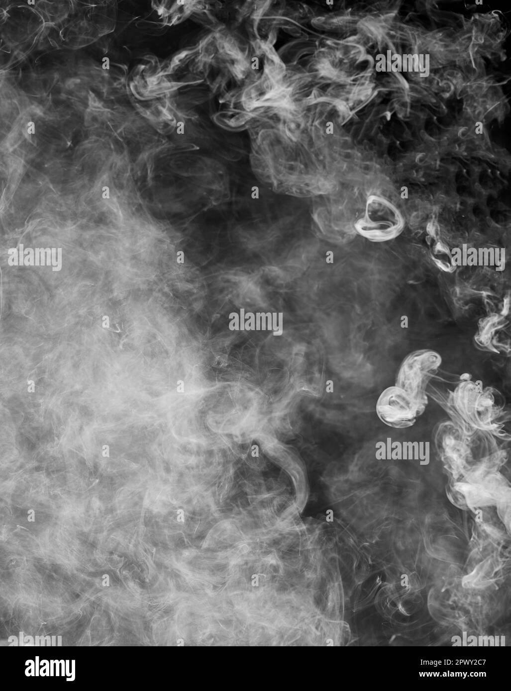 Puffs of smoke on a black background Stock Photo - Alamy