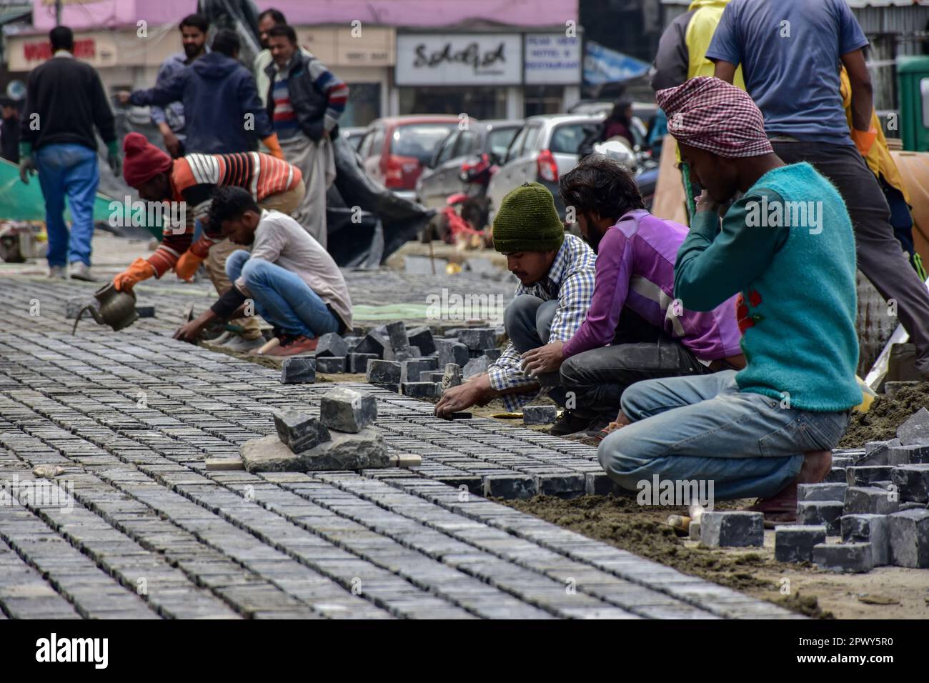 Srinagar, India. 01st May, 2023. Labourers work at a construction ...