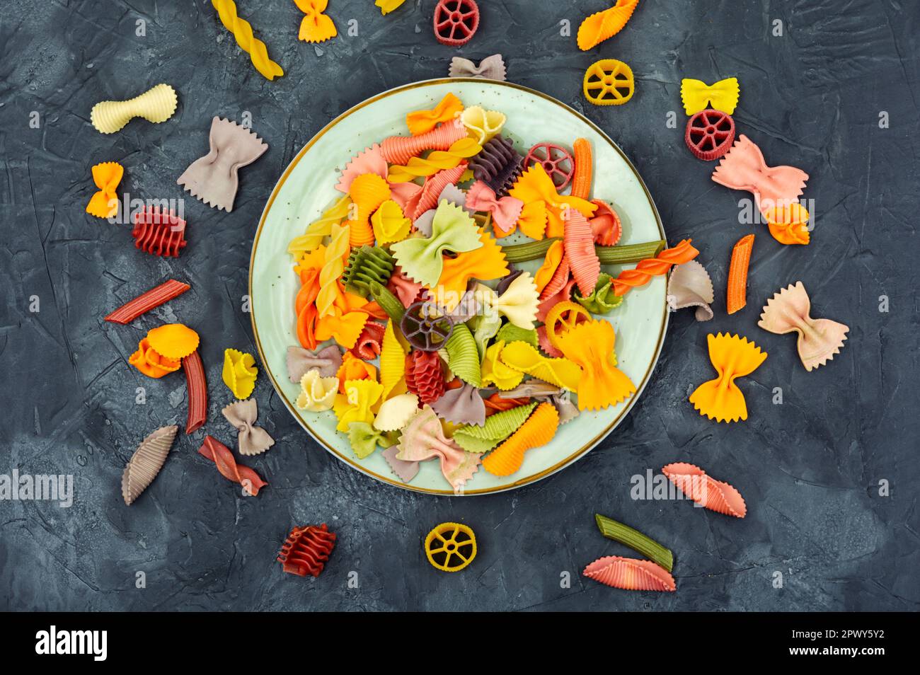 Colorful italian raw pasta on plate. Different types of Italian pasta ...