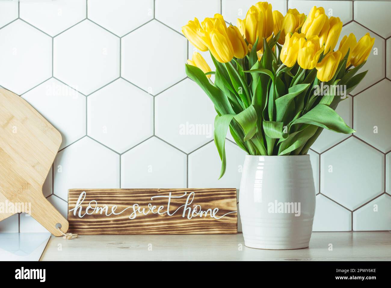 Interior shot. Home sweet home handwritten sign on kitchen countertop ...