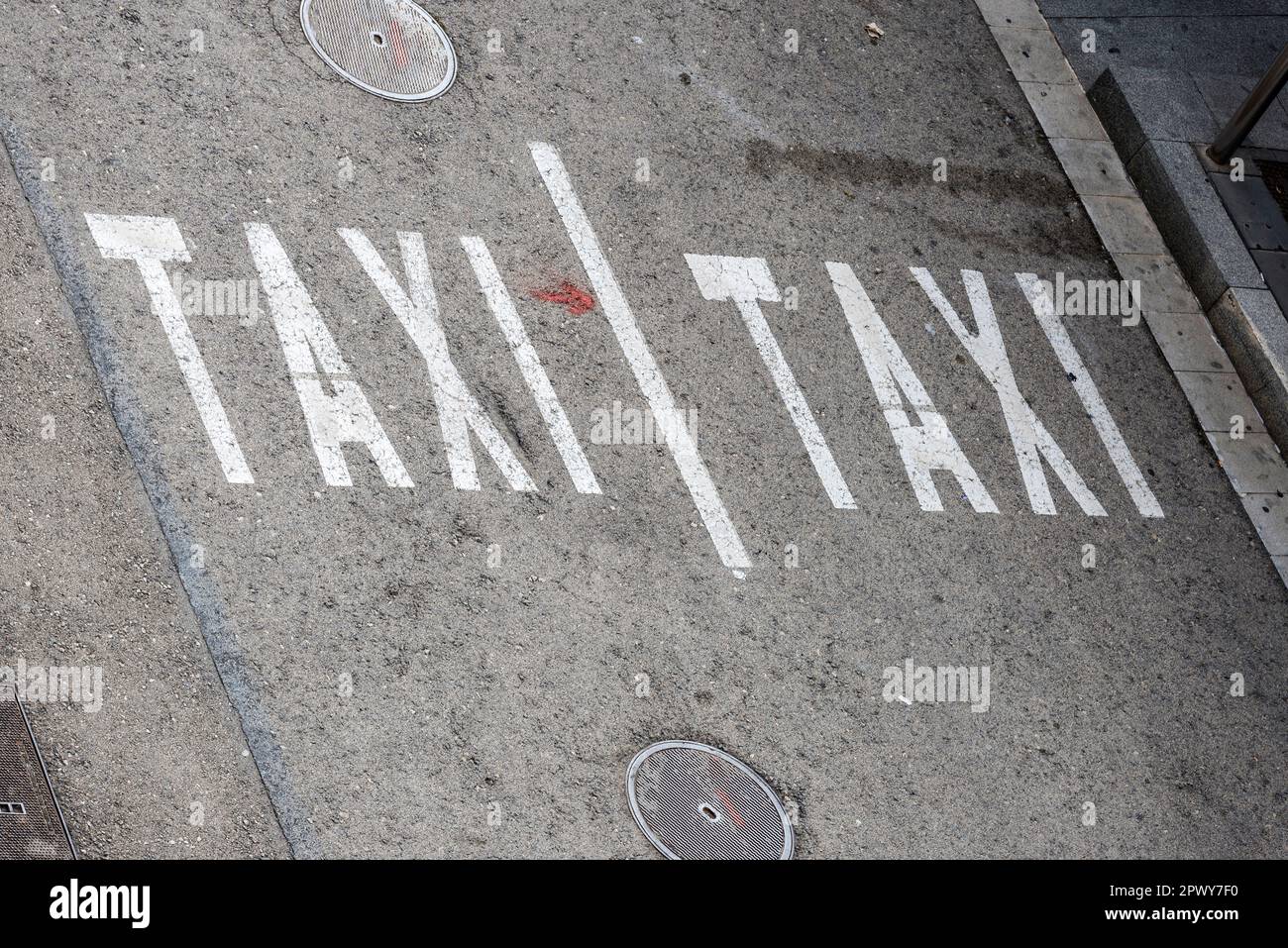 Overview of a taxi lane sign on cracked asphalt Stock Photo - Alamy