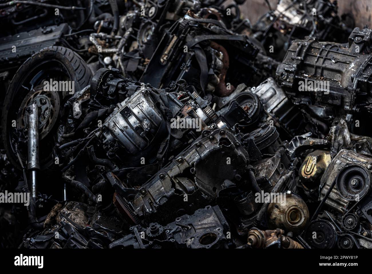 Container with engines and parts of motorcycles and cars piled up as ...