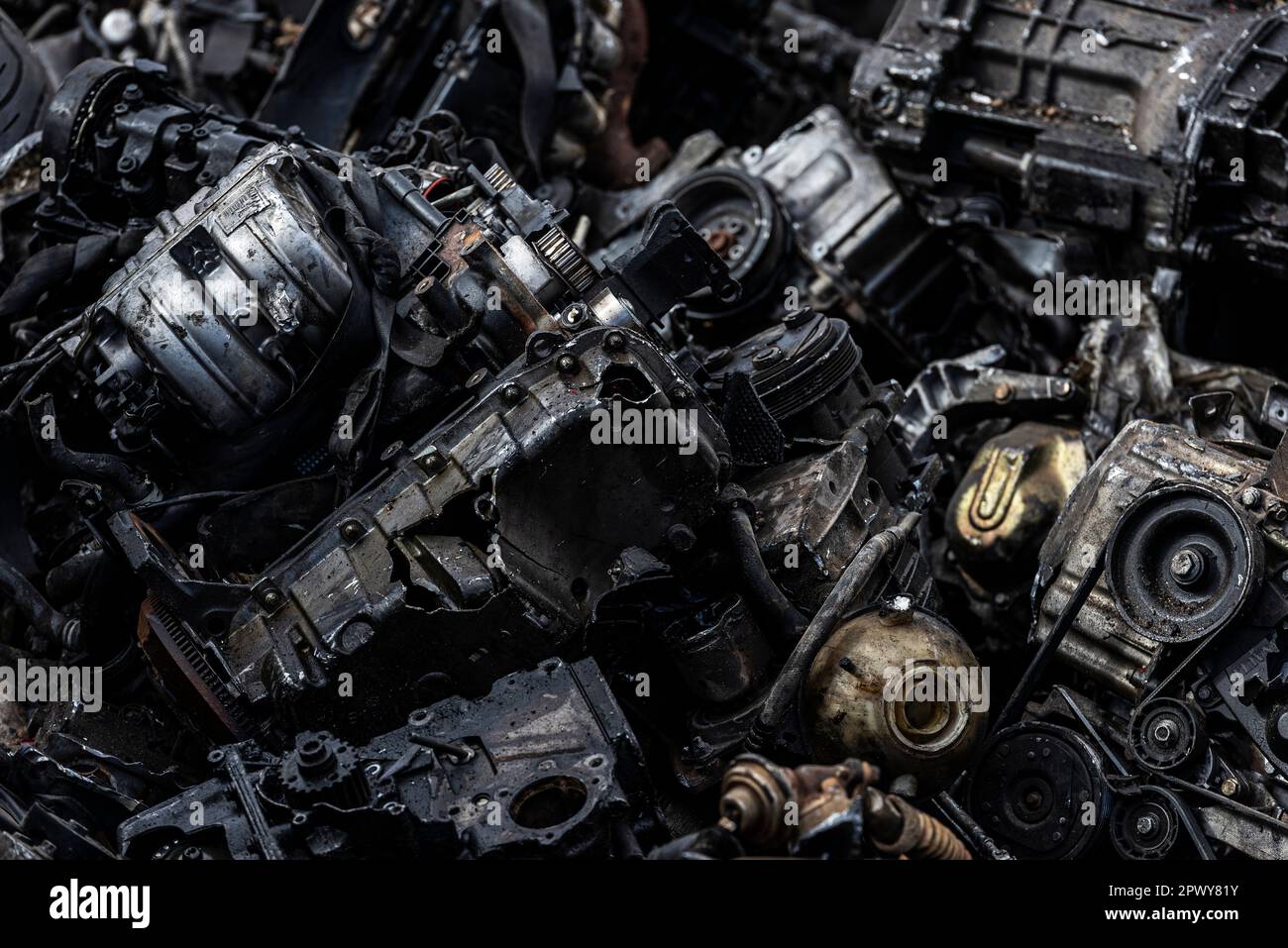 Container with engines and parts of motorcycles and cars piled up as ...