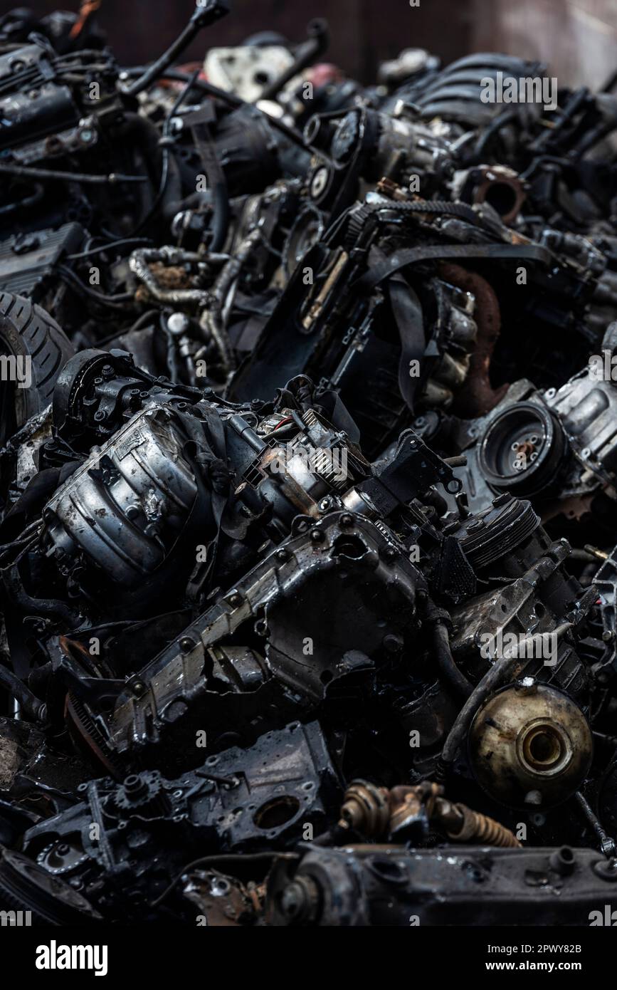 Container with engines and parts of motorcycles and cars piled up as ...