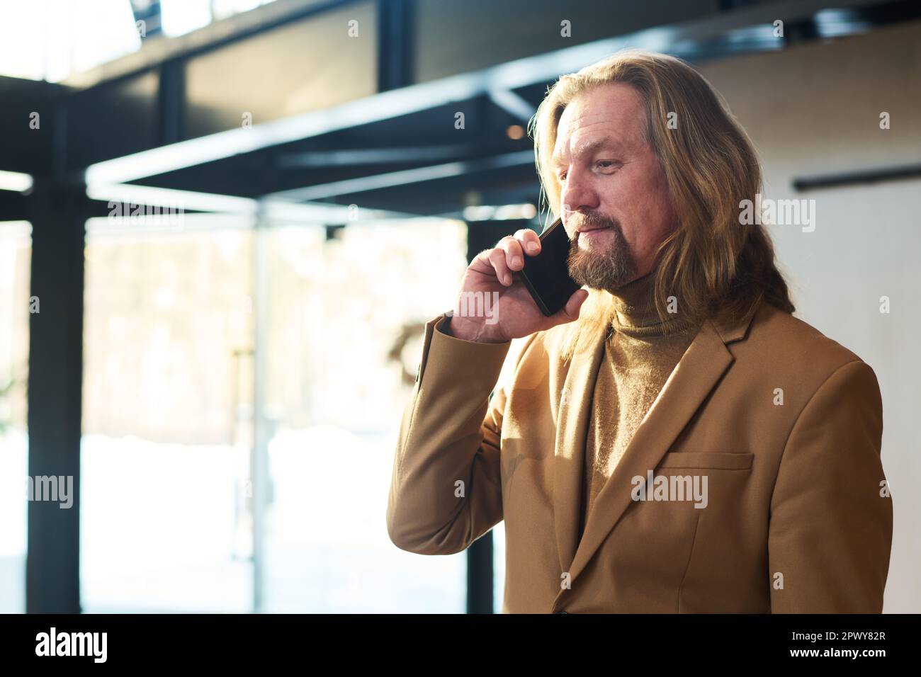 Mature bearded chief executive officer in beige jacket and turtleneck ...