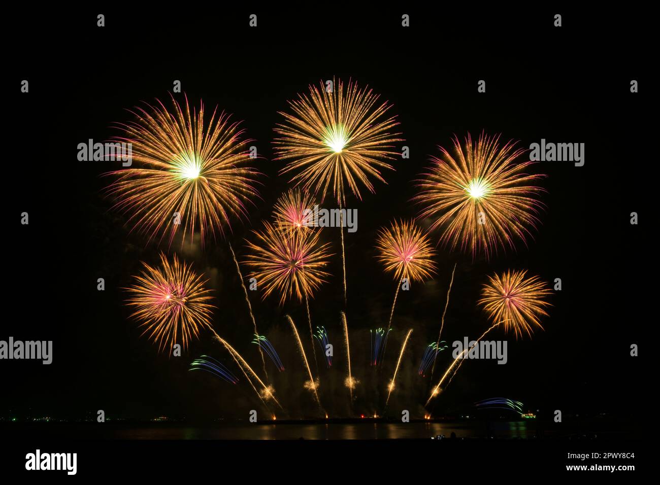 Colorful fireworks celebration from the sea with the midnight sky ...