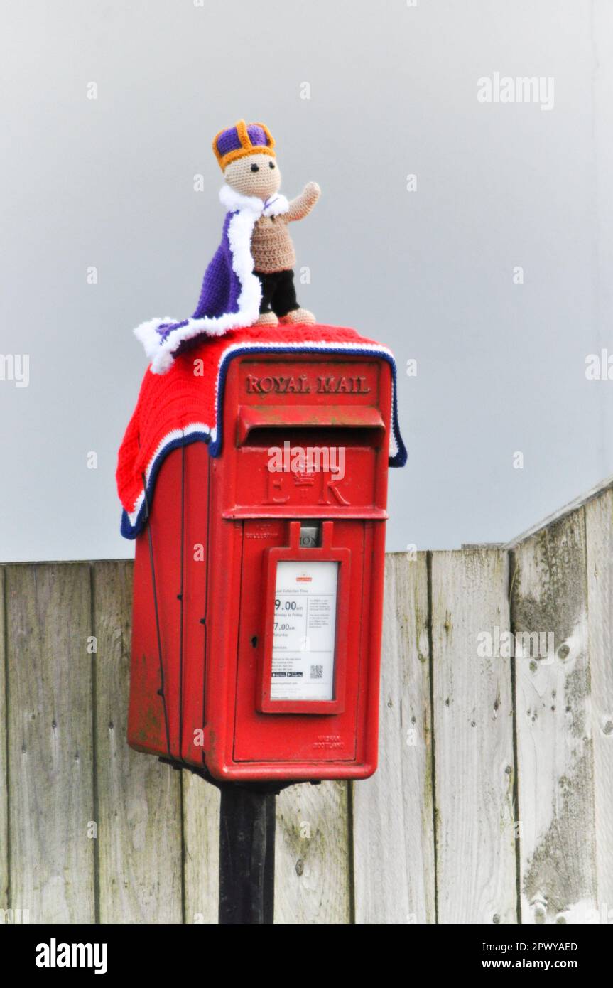 A coronation themed crocheted post box topper celebrating the ...