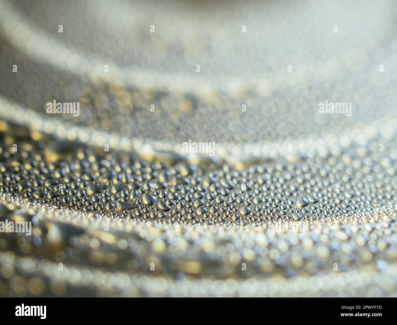 Macro view of drops on golden cold lid of canned beverage. Canned drink ...