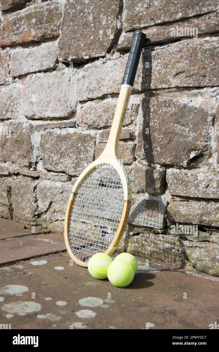 Three tennis balls and vintage racket on the path Stock Photo - Alamy