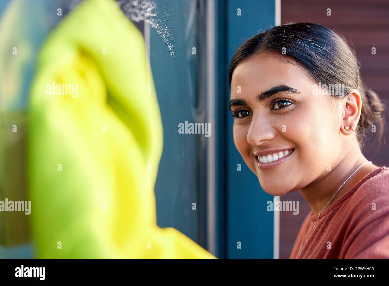 Woman, cleaning and window washing with a smile to clean windows dirt ...