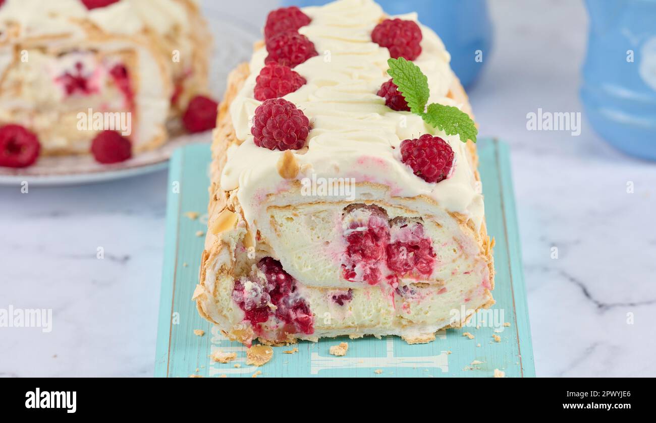 Baked meringue roll with raspberries. Whipped egg whites and ...