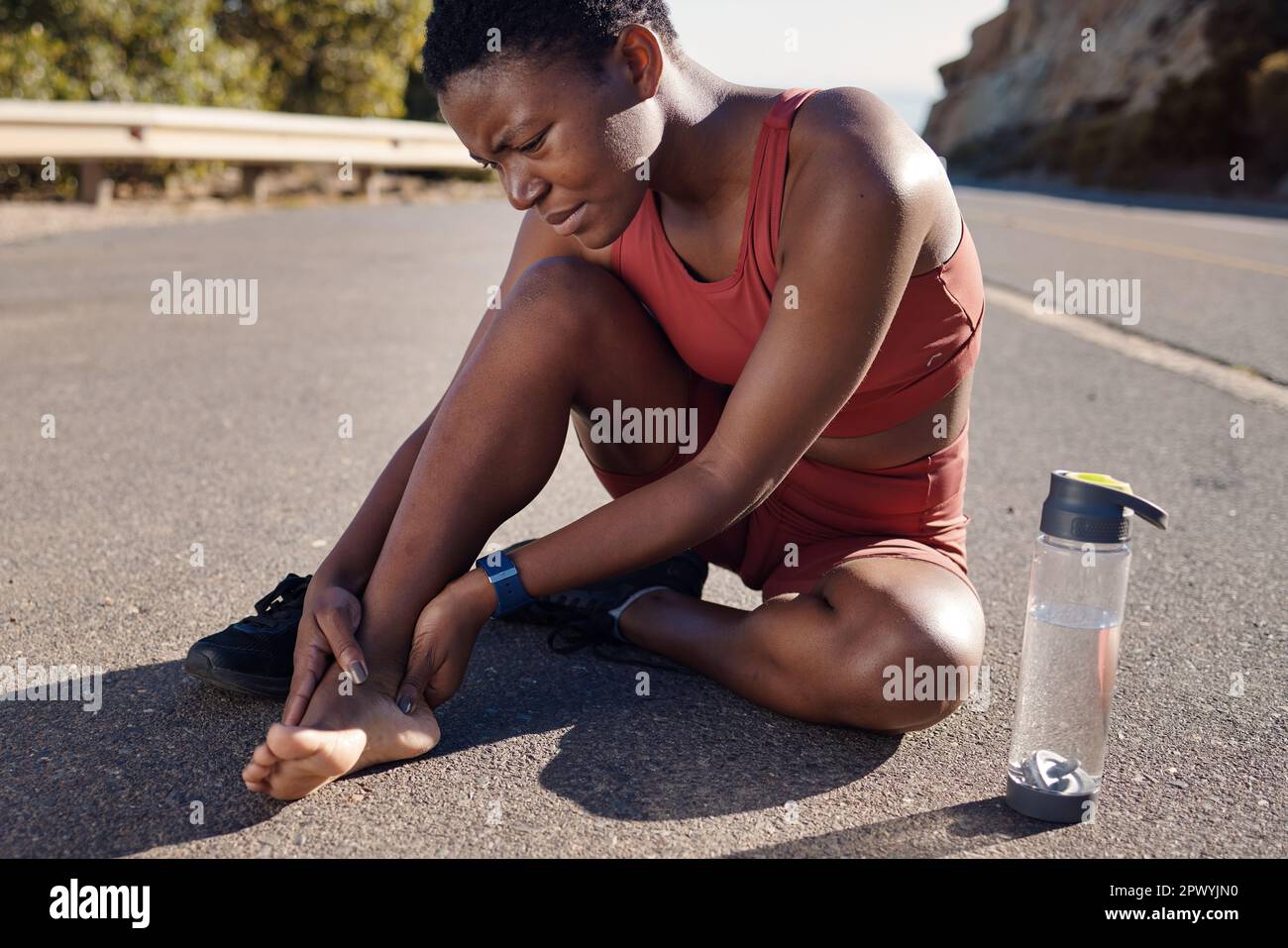 Tired female athlete stretching hi-res stock photography and images - Alamy